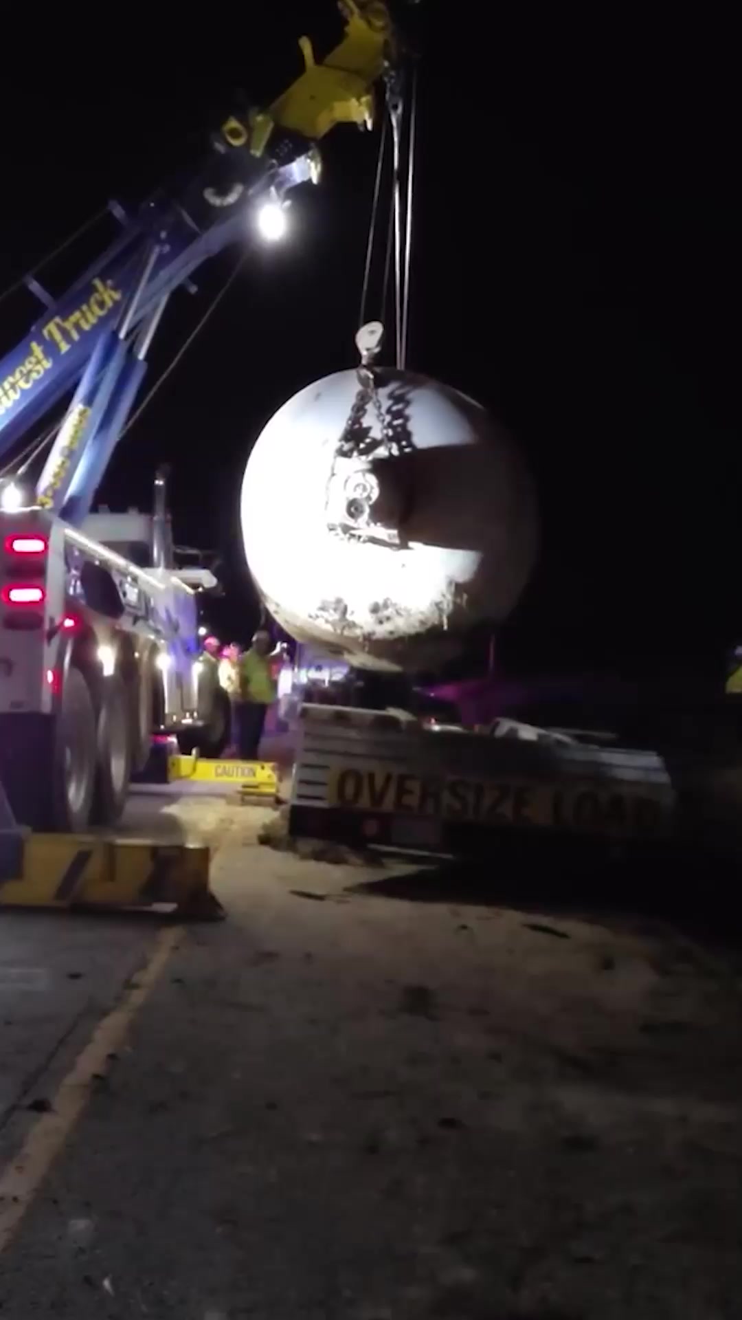 Moving a giant spherical tank at midnight
