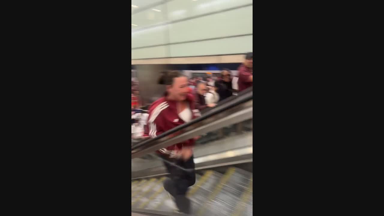 Woman reaches the top after falling on downward escalator in London, UK