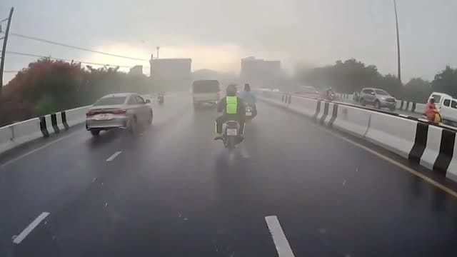 Lightning strikes motorcycle rider on busy road during storm