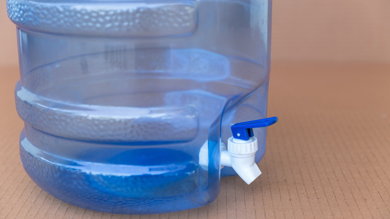 Save an old water jug to create a budget-friendly tool holder with an ...