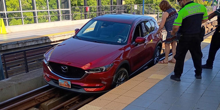 Mazda driver pulls into elevated train station on the tracks ...