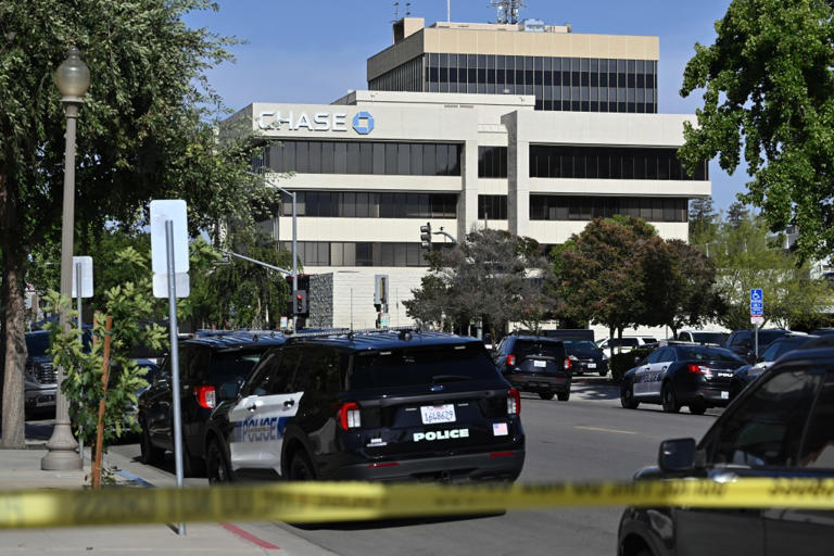 Bank robber with 'bombs strapped to him' dead and all hostages freed ...