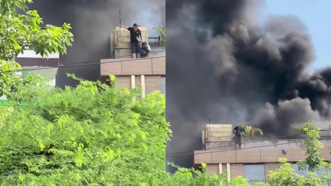 Video: No way down, foreigner clings to roof as fire engulfs Delhi hotel