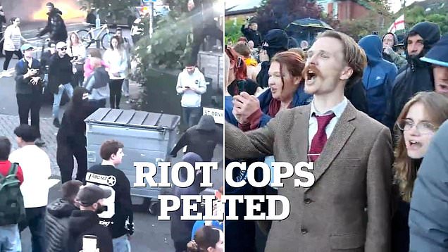 Moment protesters launch wheelie bins at riot squad officers