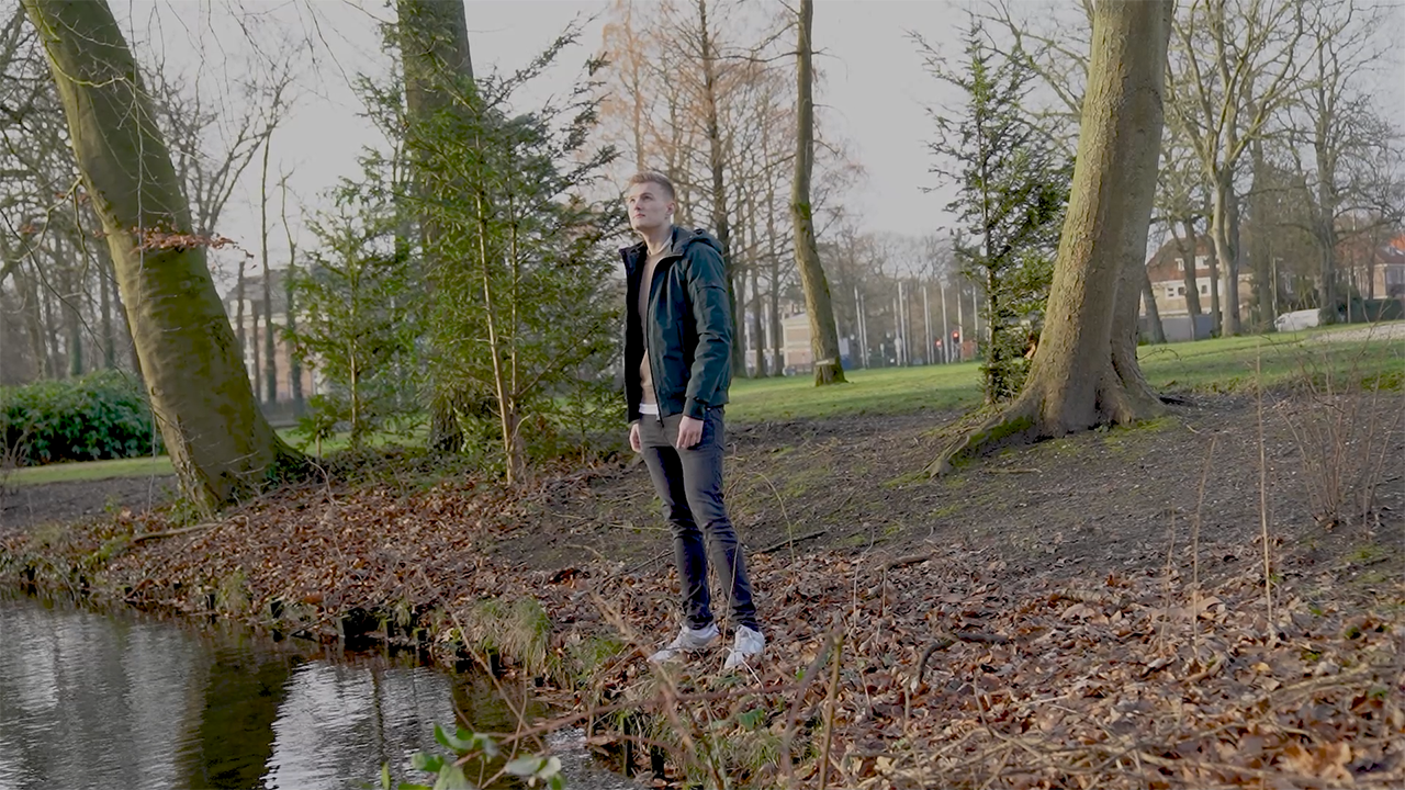 Standing beside a calm stream and admiring the natural woodland view