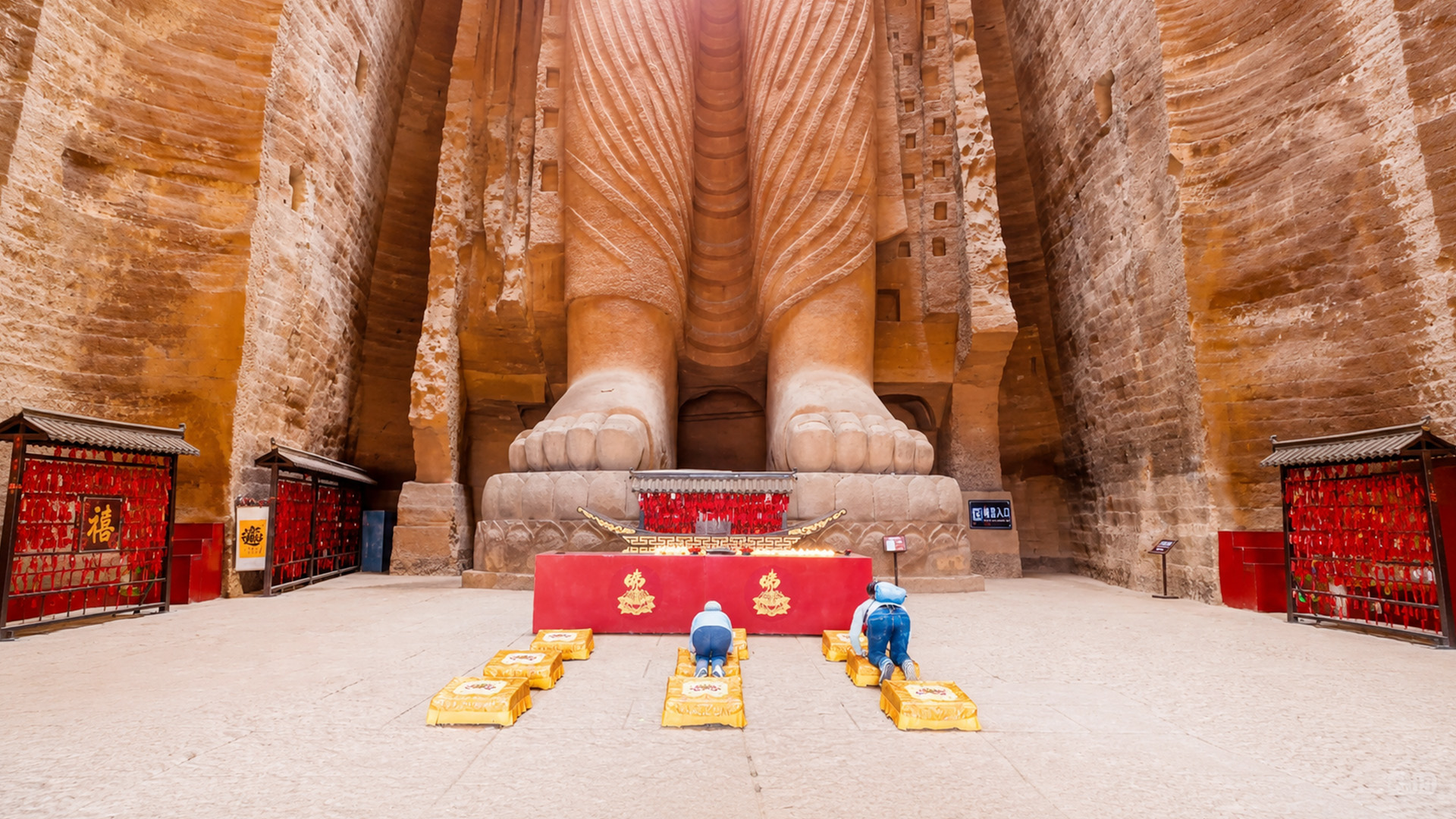 Beneath a towering stone giant lies a place of worship