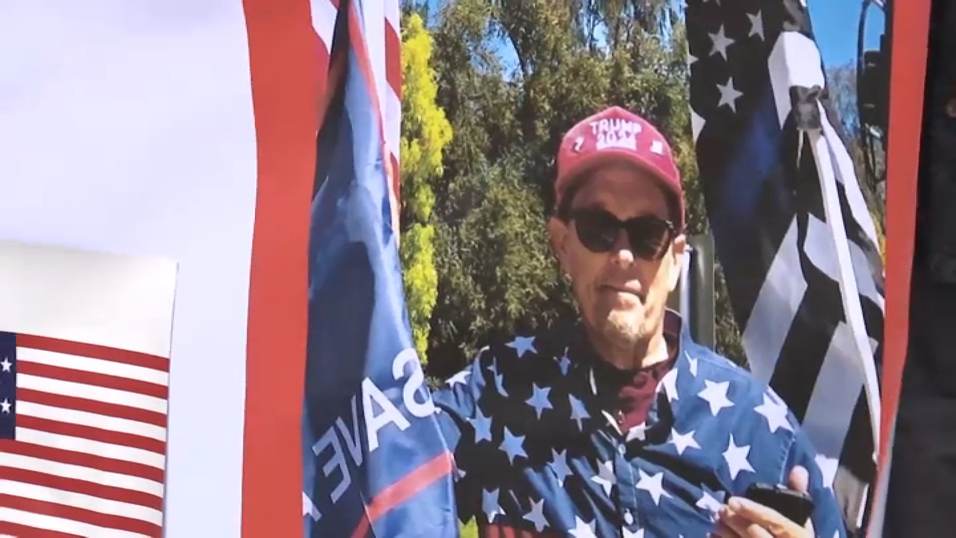 Suspect now faces murder charge in killing of man outside Trump-themed home