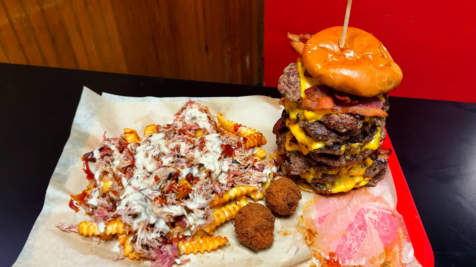 He takes on giant 8-patty bacon cheeseburger challenge with loaded fries