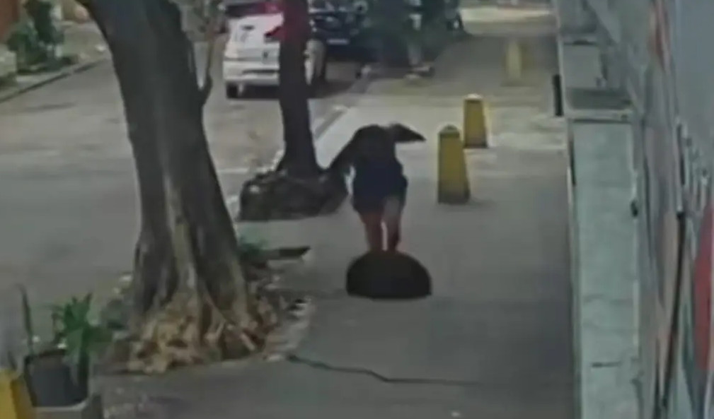 Shocking video shows woman fall into manhole after cover gives way ...