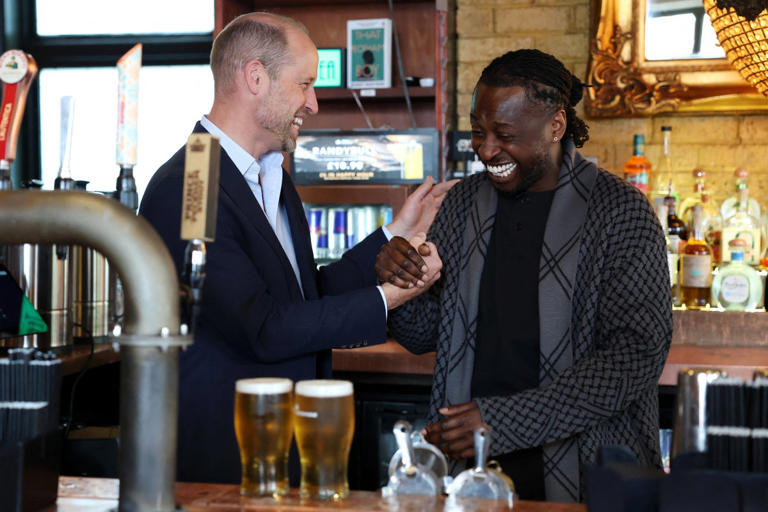Prince William spotted pulling pints behind the bar at London pub