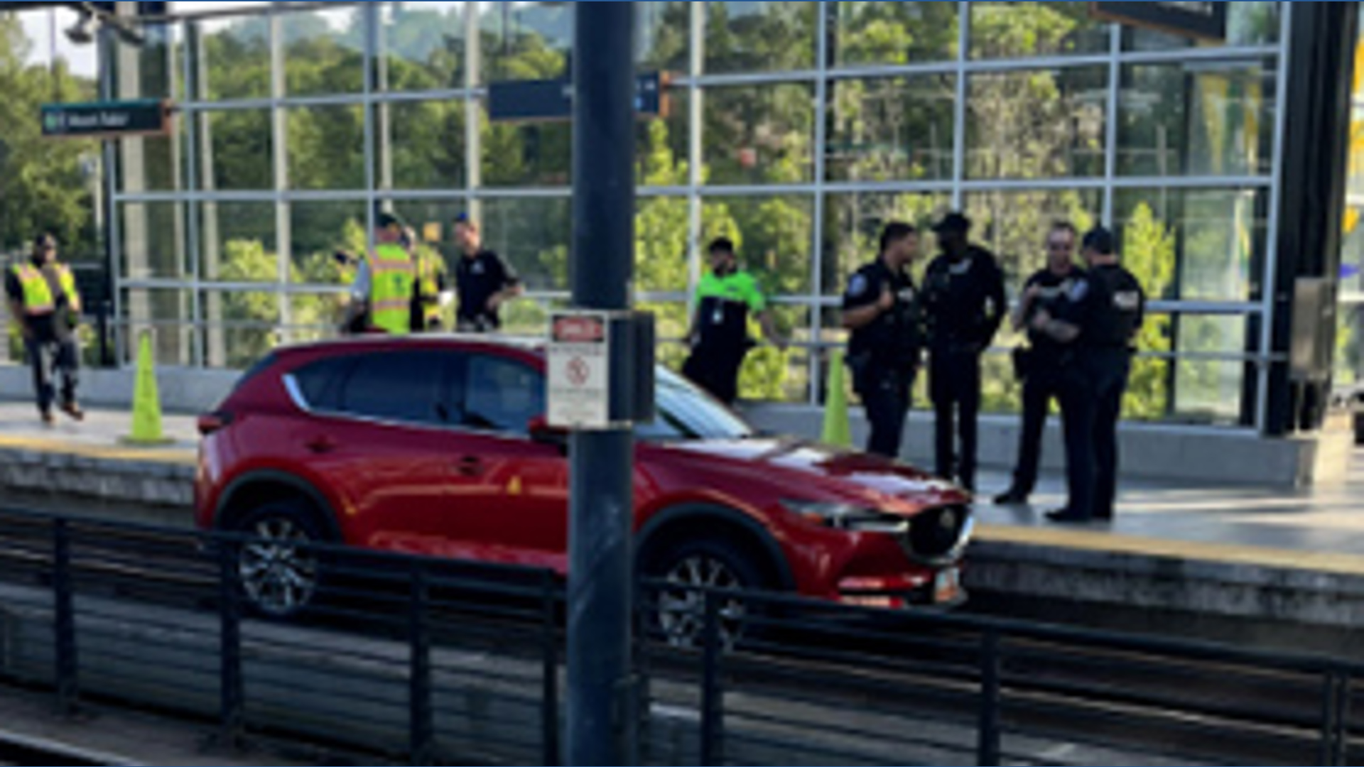 Car drives onto elevated light rail tracks