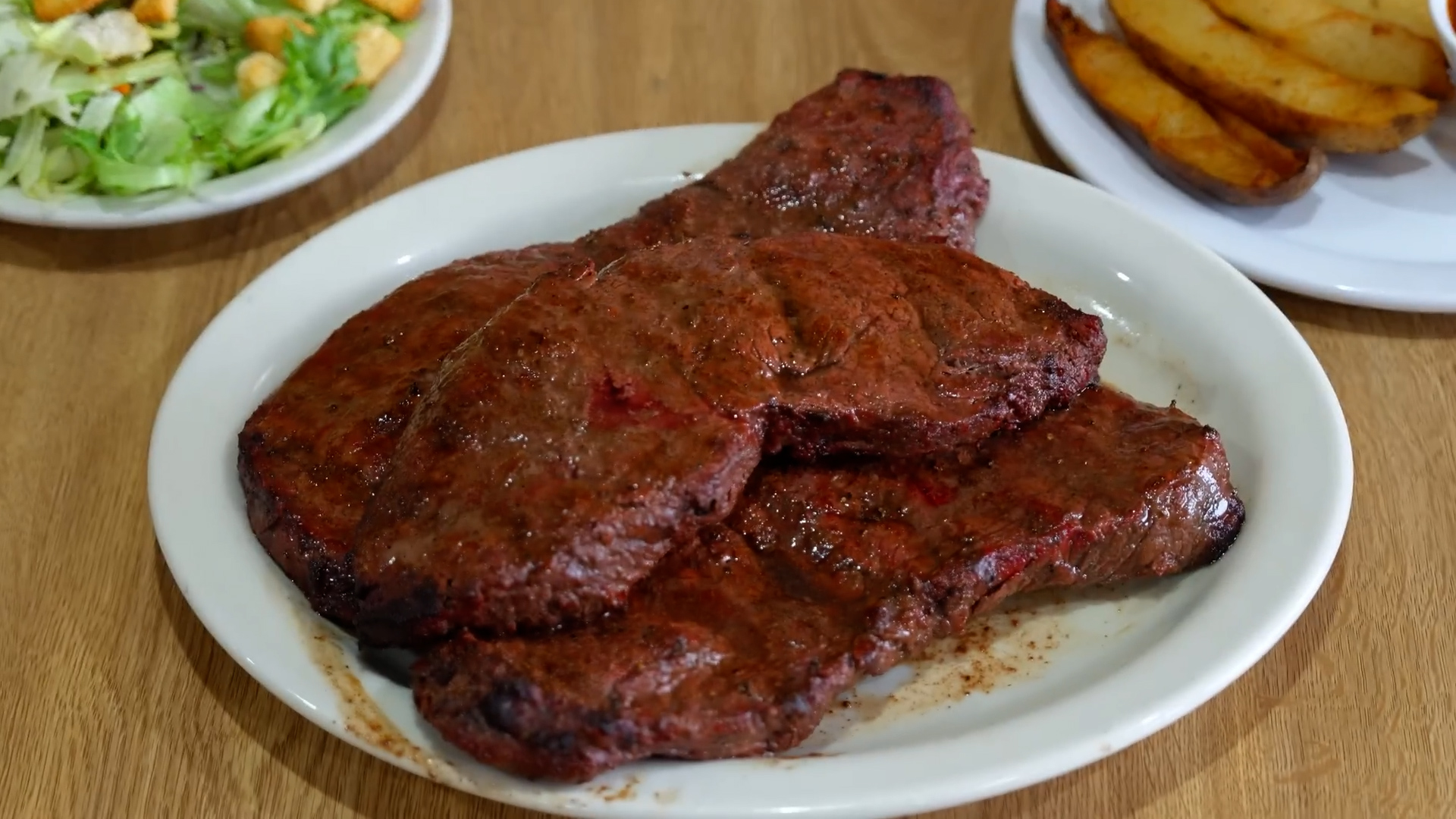 Man tries to eat three huge ribeye steaks in under one hour