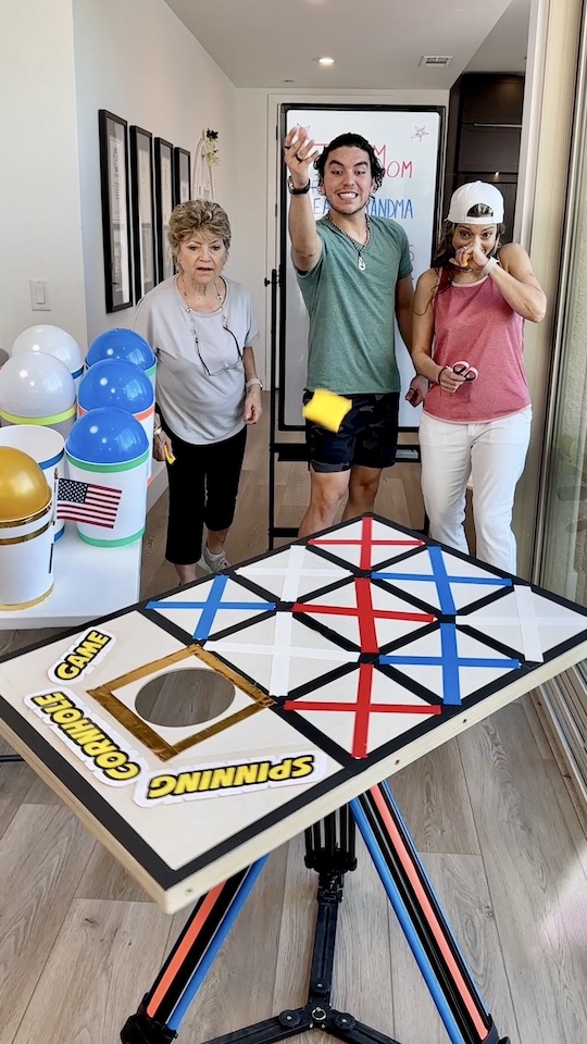 Spinning cornhole challenge with prize winning throws