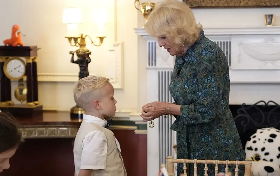Queen Camilla pins bravery medal on seriously ill boy