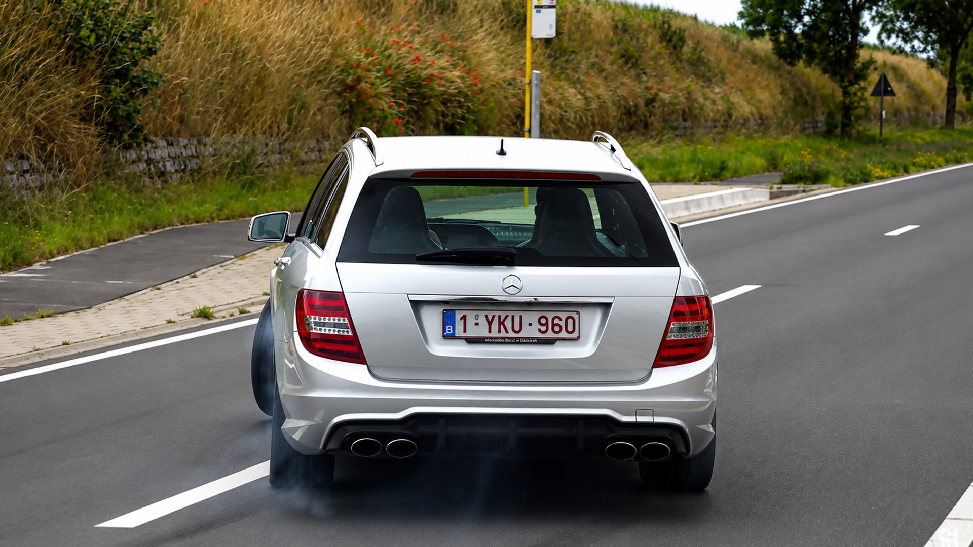 Mercedes C63 AMG nearly slides during hard acceleration on public road