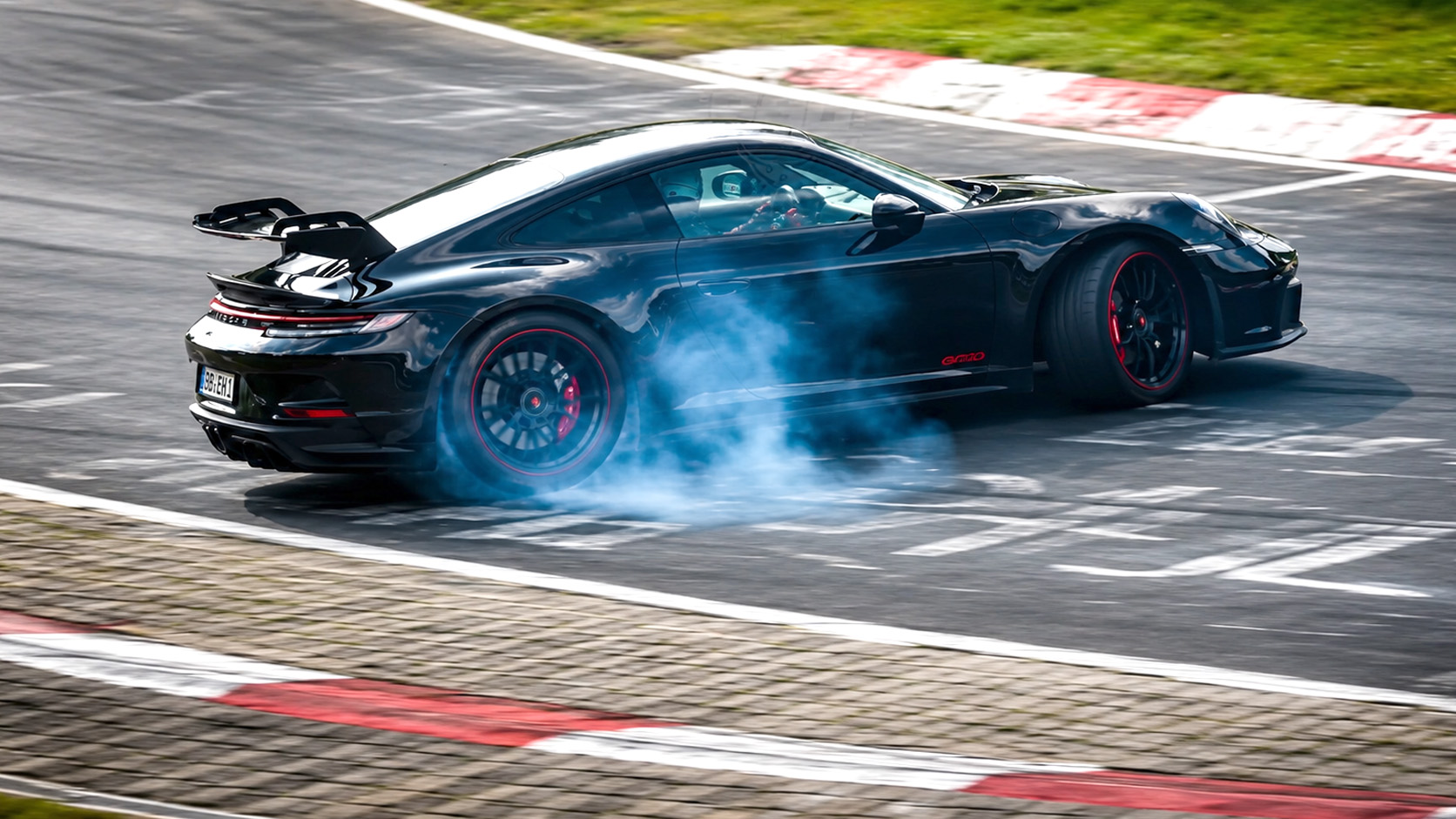 Porsche spins out mid-corner creating a massive smoke-filled close call