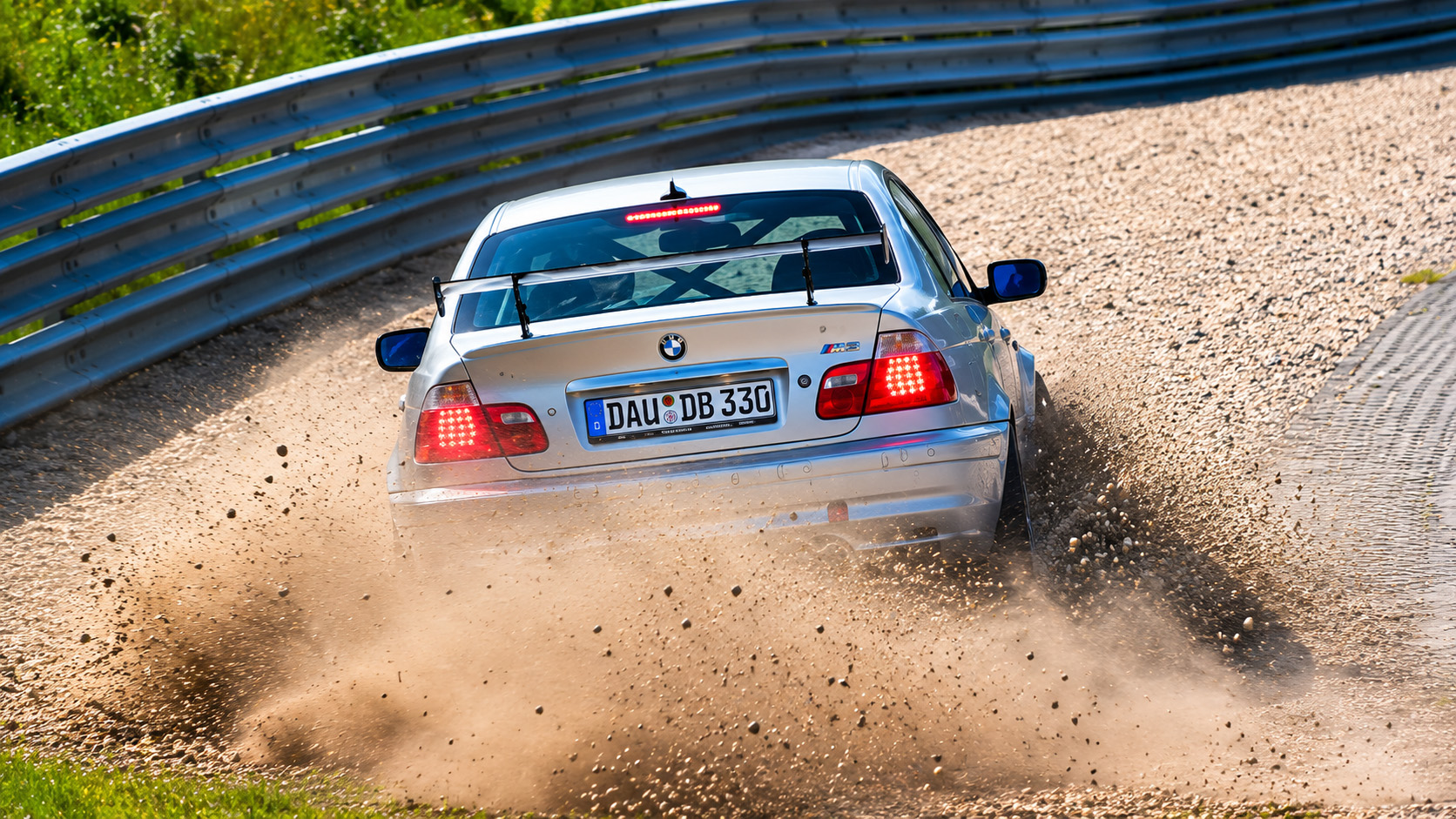 BMW driver nearly hits the barrier after going off track