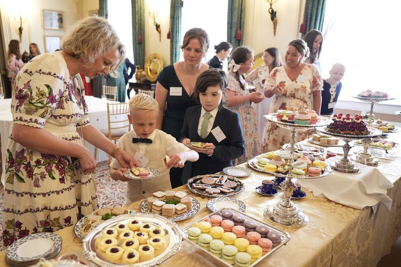 Gravely ill little boy tells Queen 'what a happy event' as Camilla ...