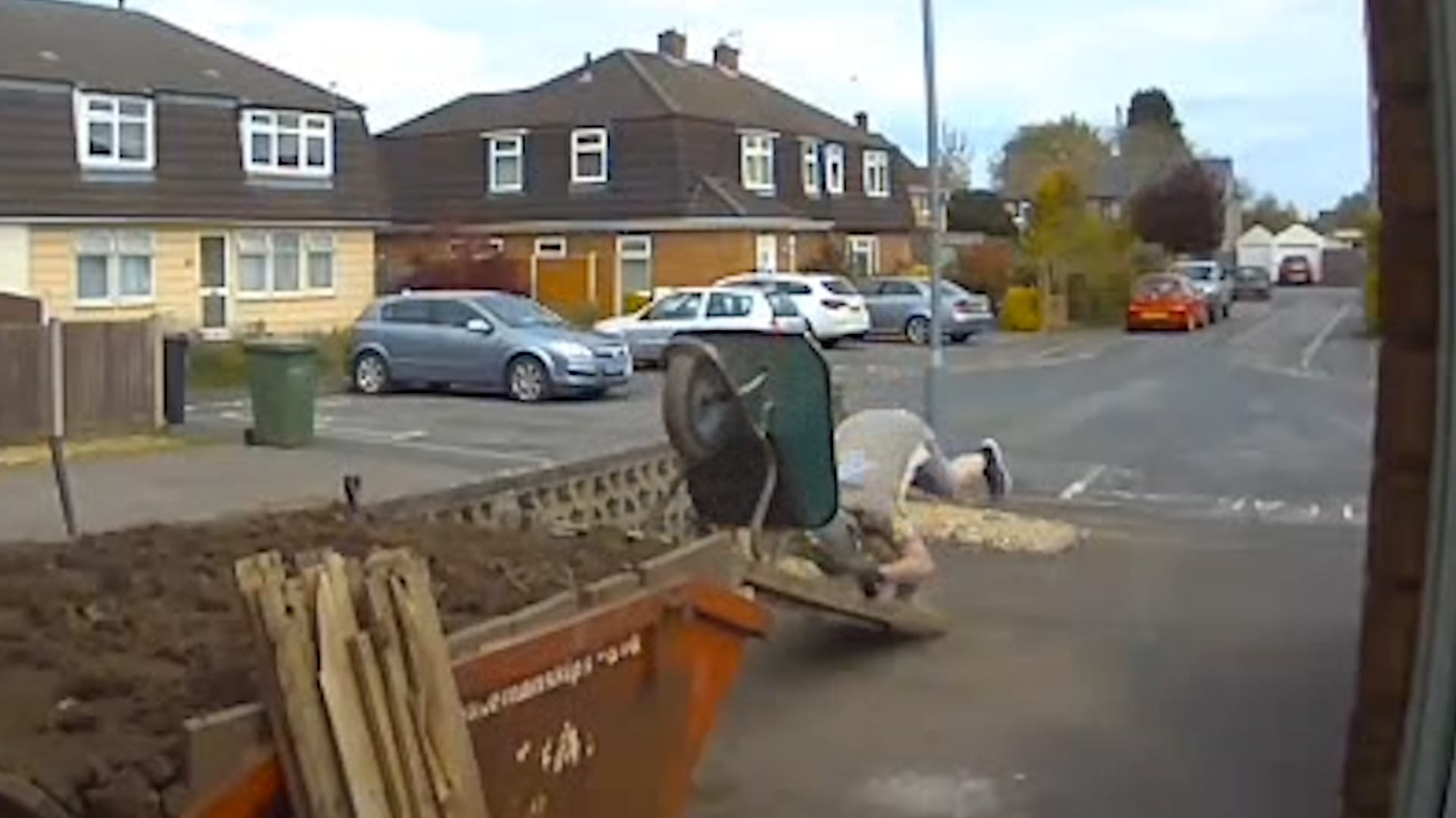 Moment gardener's wheelbarrow tips over - covering him in soil