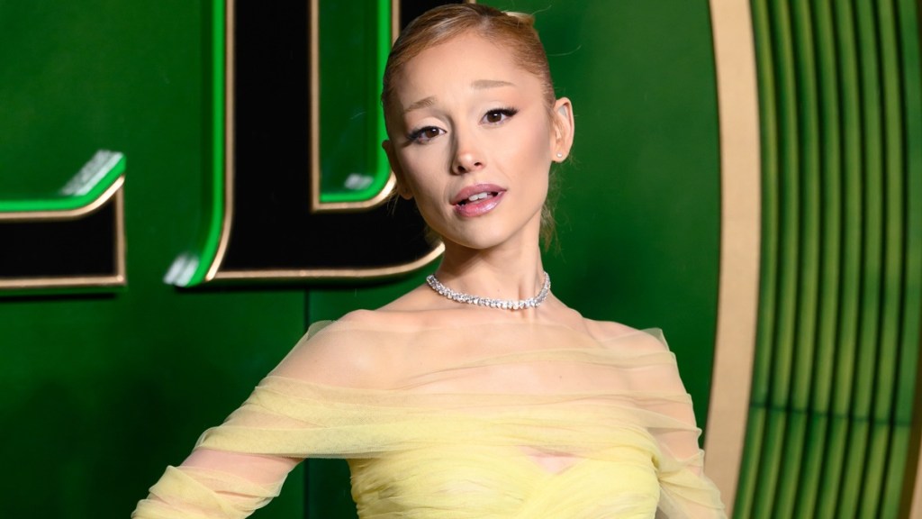Ariana Grande layers Swarovski bling over plunging sheer micro minidress