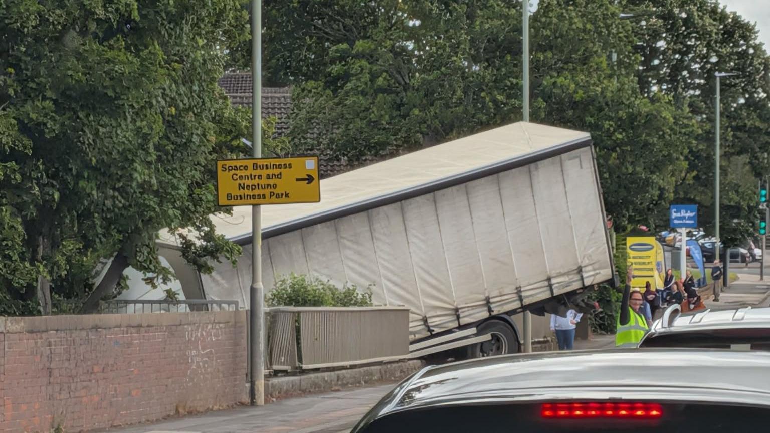 Lorry left hanging off side of bridge after crash