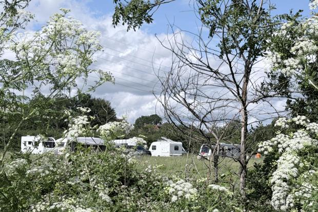 Travellers set up camp near new housing estate on former car boot site