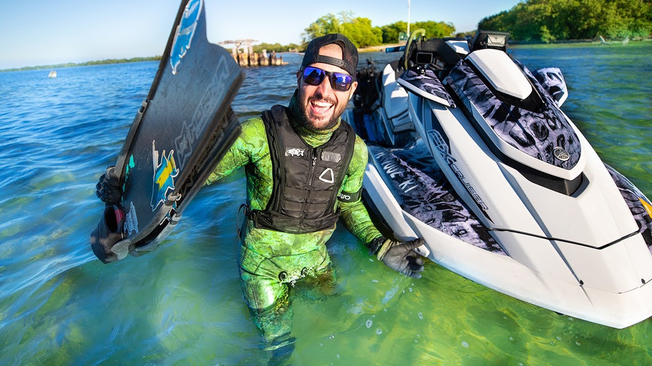Supercharged jet ski spearfishing in crystal-clear water