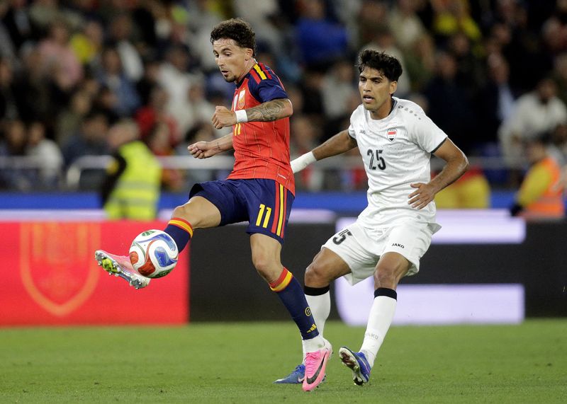 Soccer-second-string Spain held by Iraq in low-key World Cup send-off