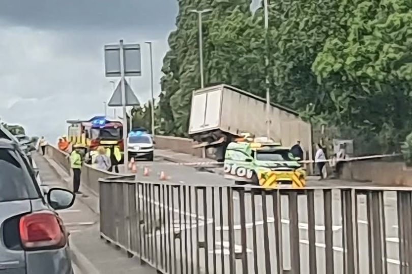 Dramatic Cheltenham crash in pictures as lorry left hanging over bridge