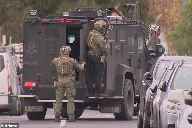 Stay inside warning issued as heavily armed police surround Melbourne ...
