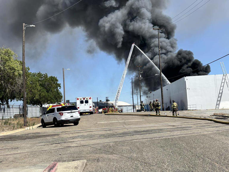 Two-alarm warehouse fire sends black smoke visible for miles near ...