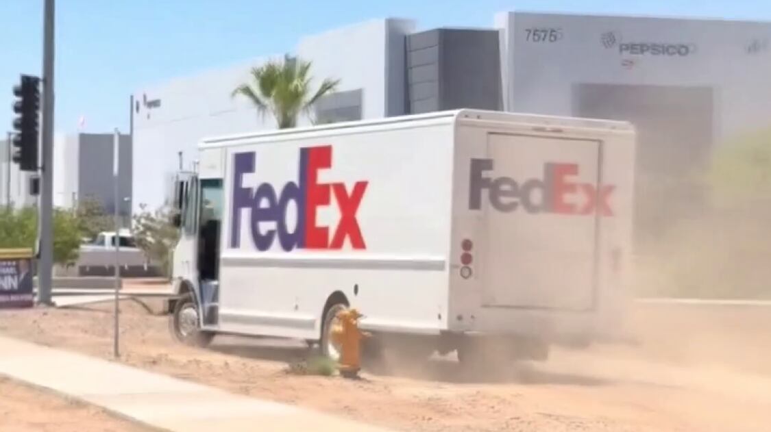 FedEx driver caught on video driving on sidewalk, running red light in ...