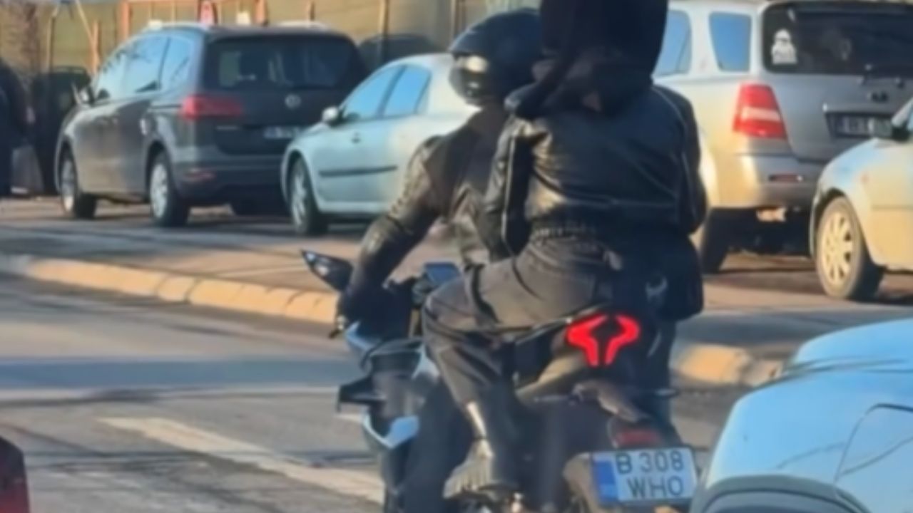 Passenger loses balance on motorcycle and falls behind bike