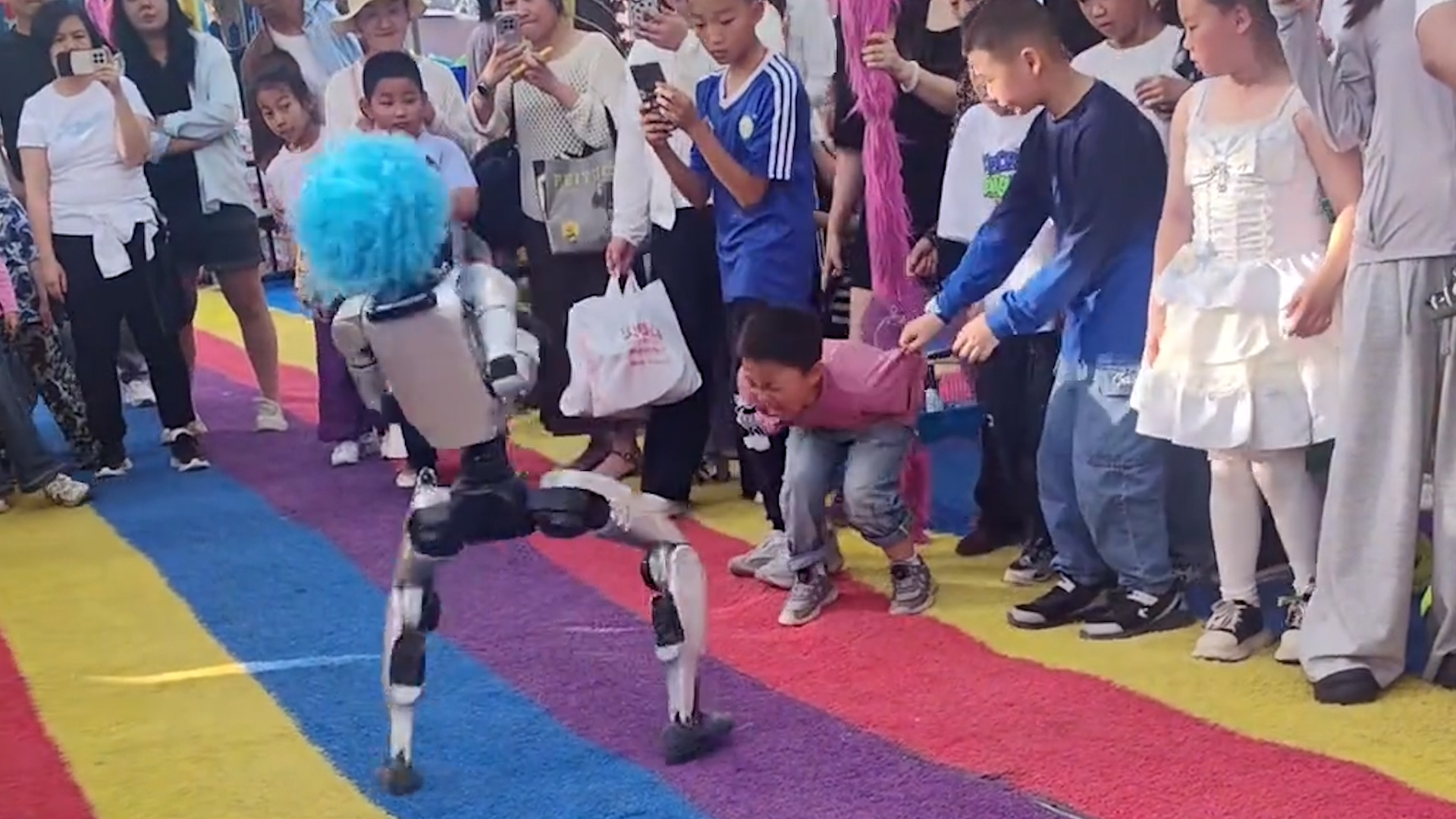 Robot accidentally kicks boy to ground during martial arts display