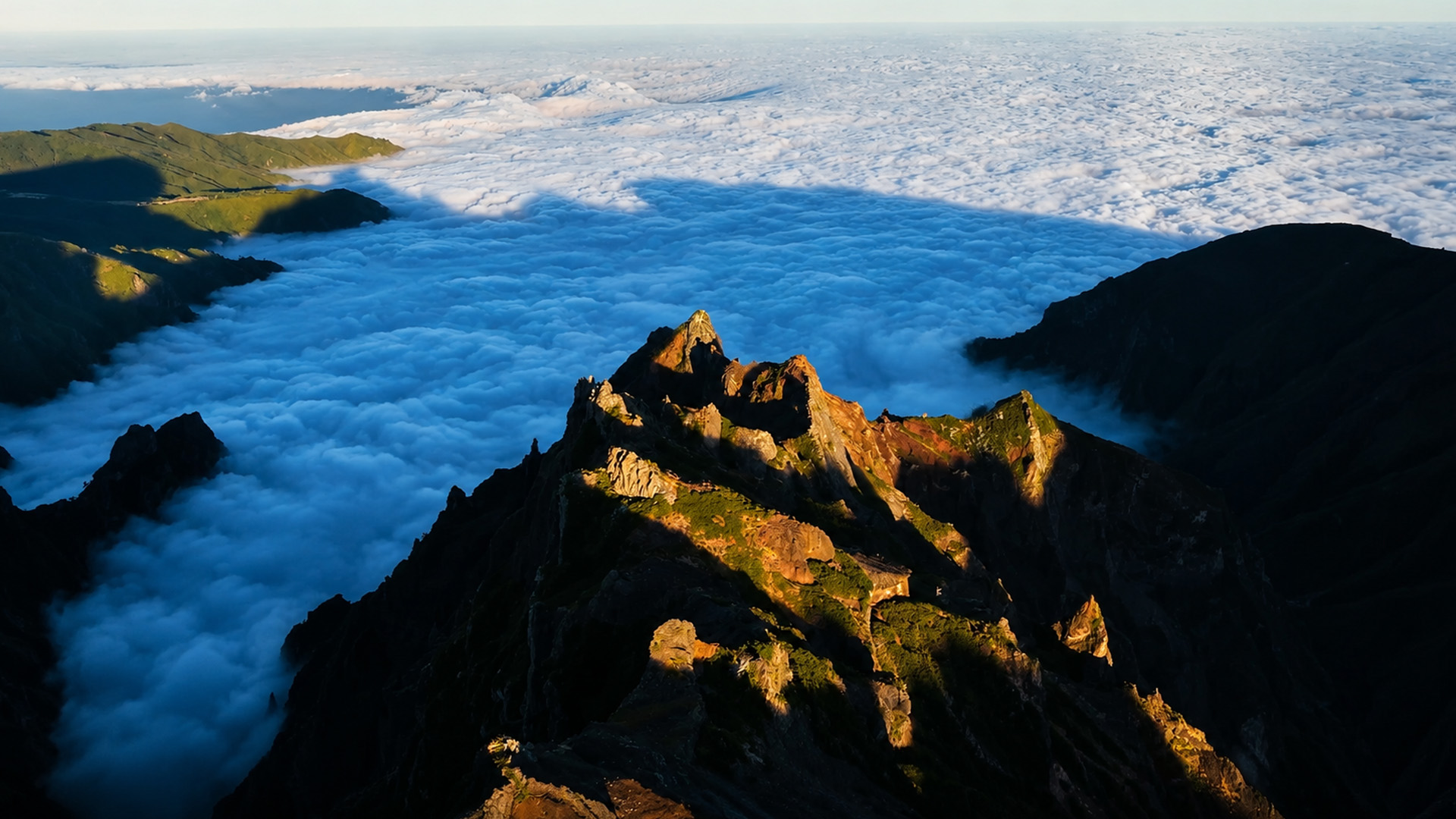 A mountain peak floating over the ocean