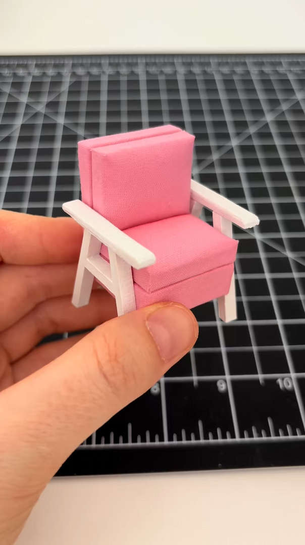 Single pink chair with wooden armrest