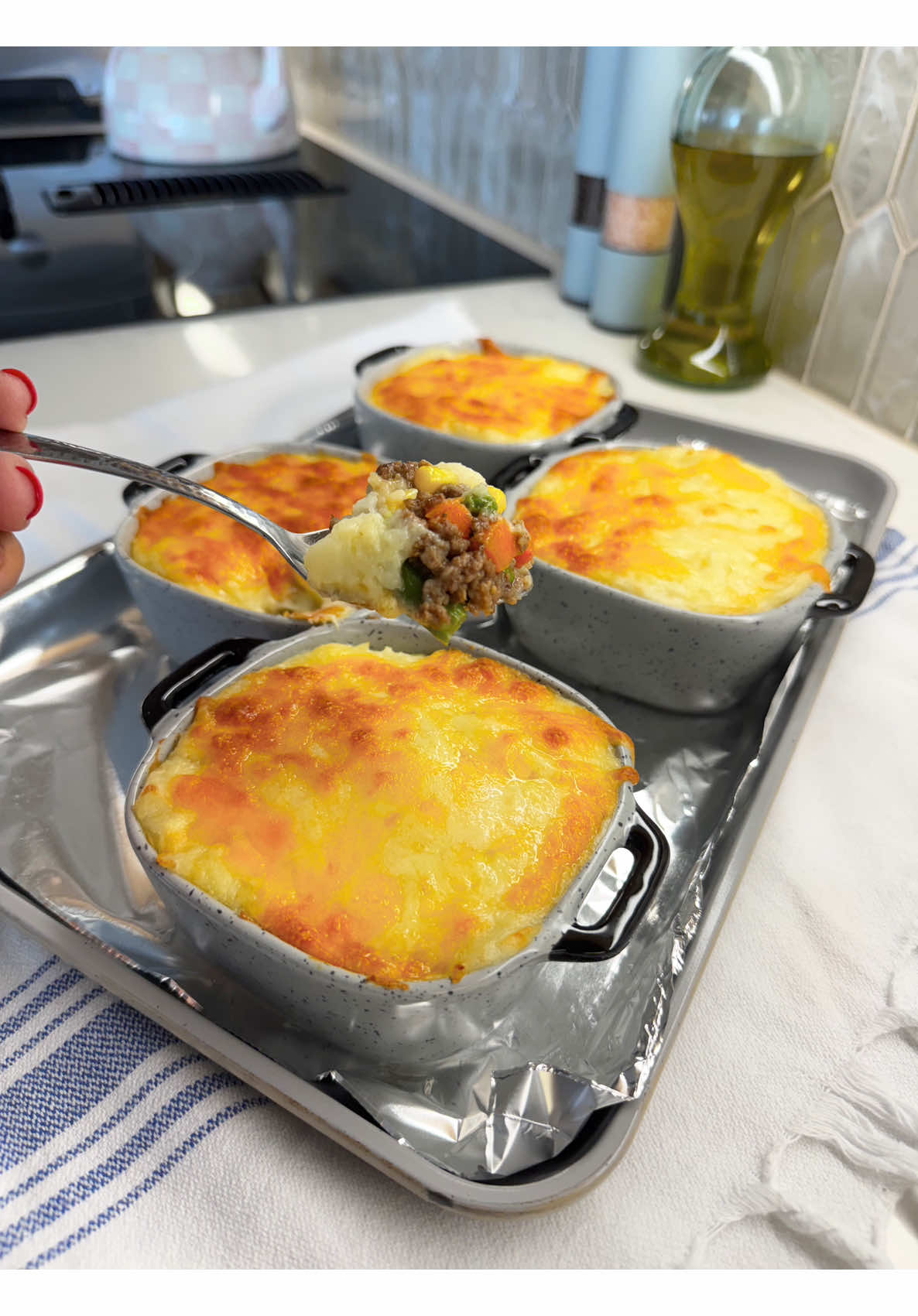 Homemade individual shepherd's pies with a golden mashed potato topping ...