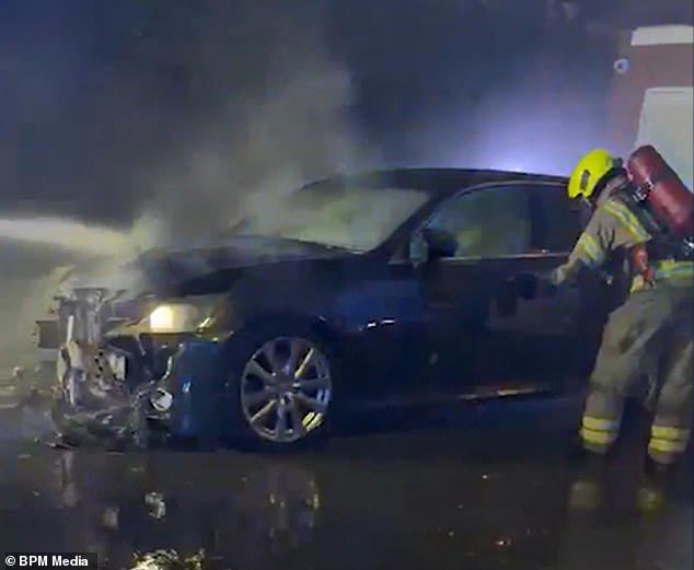 Moment arsonists set fire to car at family home of left-wing politician ...