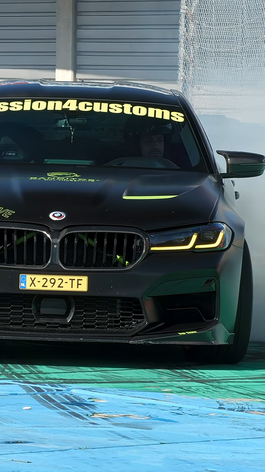 BMW M5 performing a burnout before the race