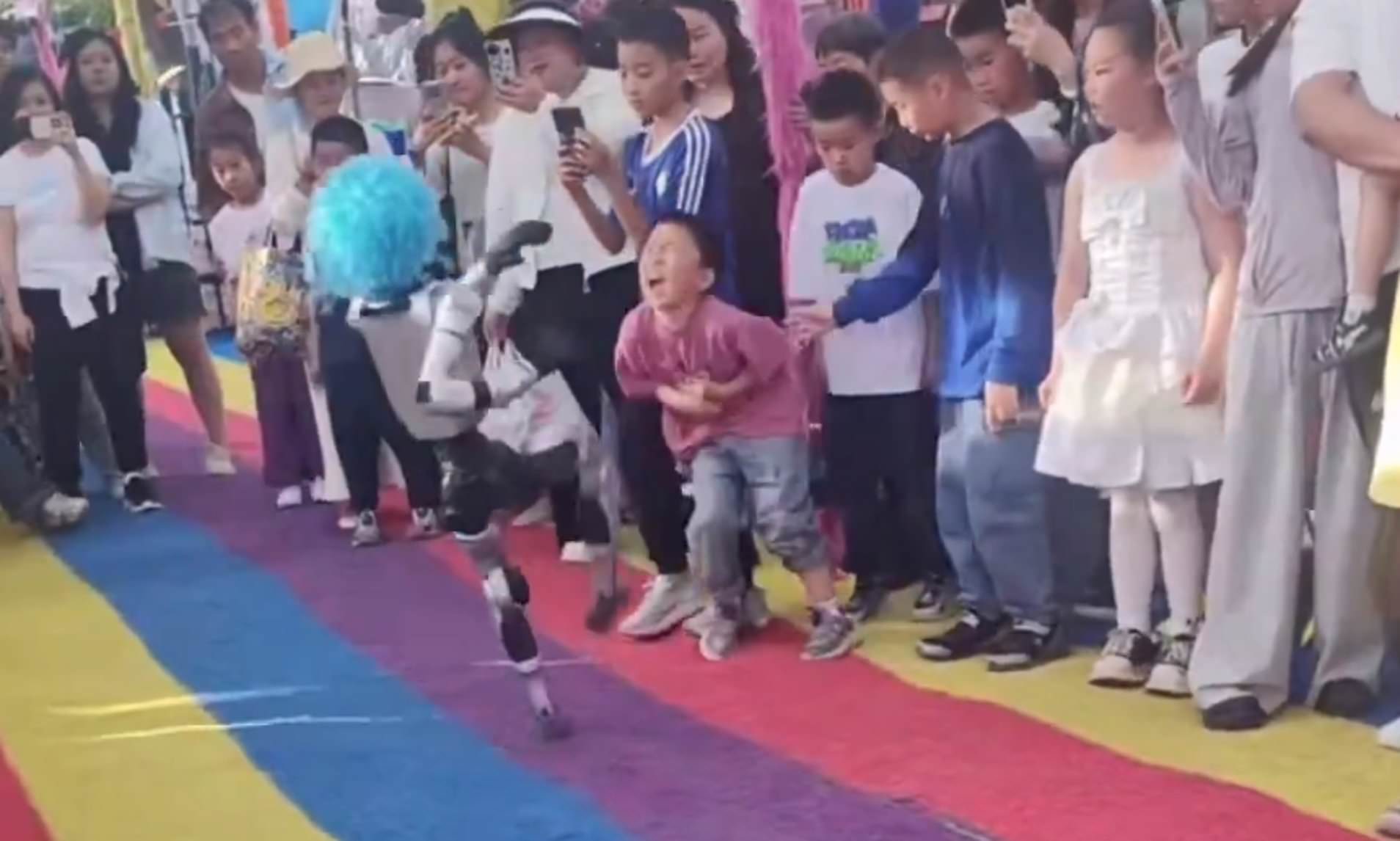 Out-of-control robot karate kicks a child in the stomach while ...