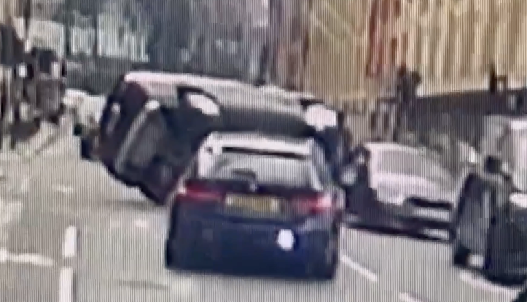 Moment police car flips onto side during central London chase