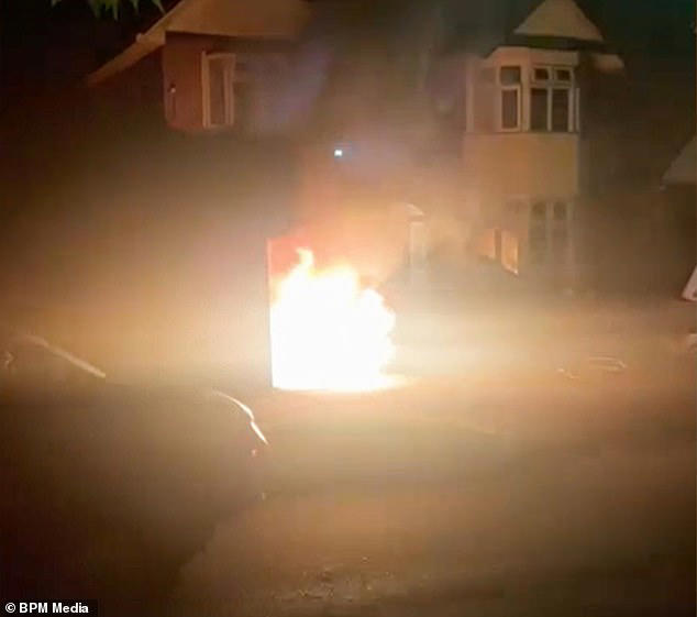 Moment arsonists set fire to car at family home of left-wing politician ...