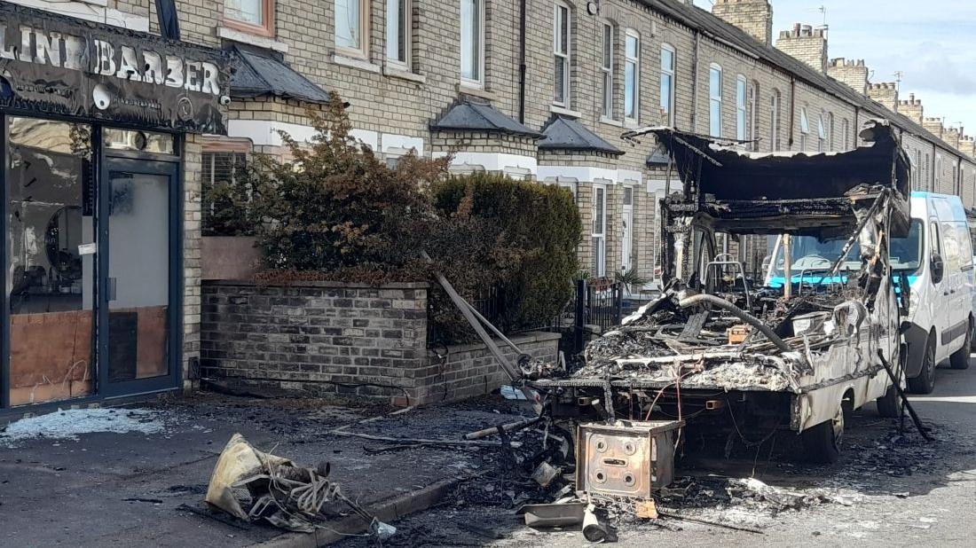 Exploding campervan damages buildings and cars