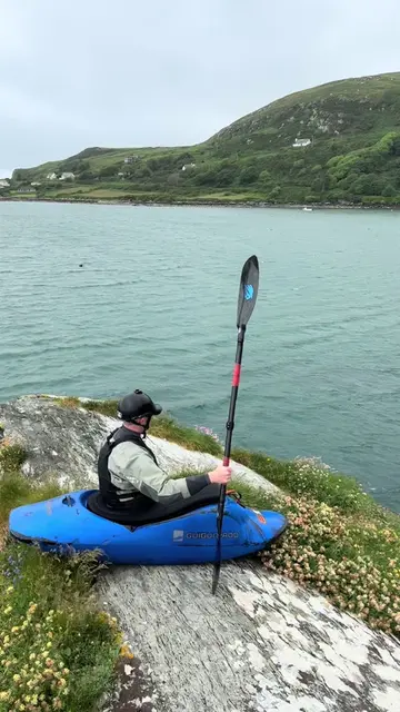 Kayak Slide Into The Bay From A Rocky Slope