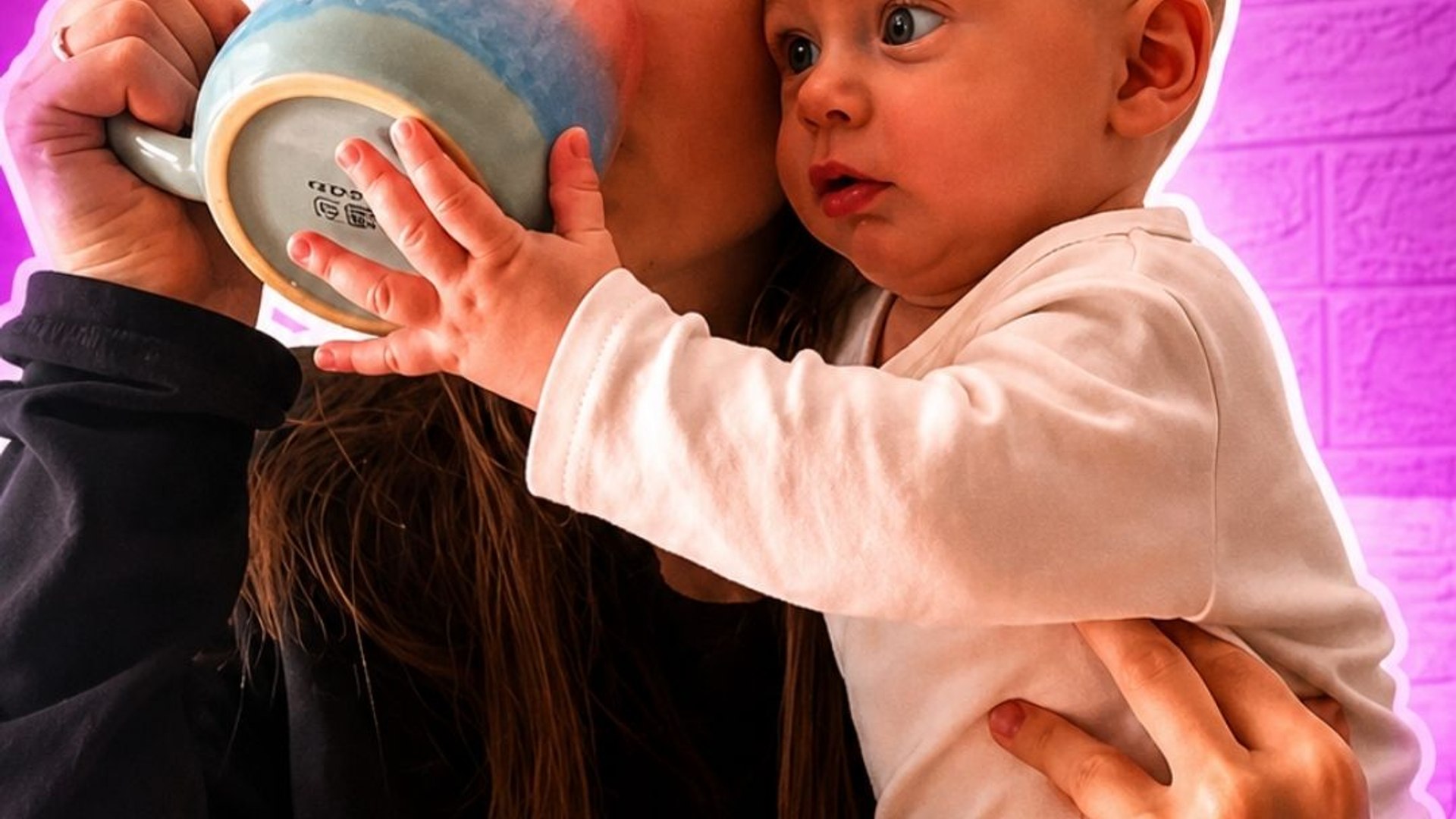 The baby reaches for the girl’s mug every time she tries to take a sip