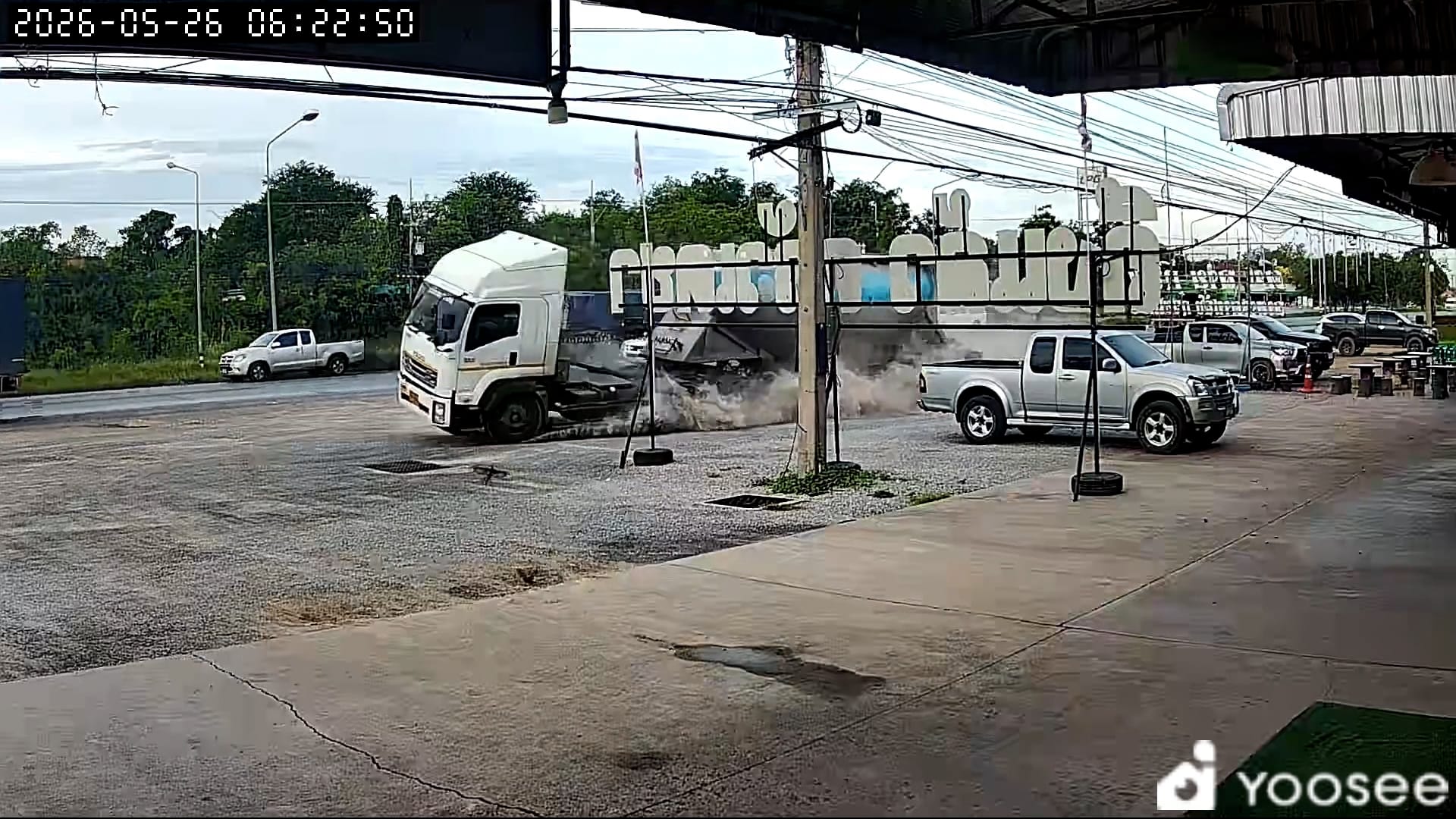 Out-of-control tanker truck overturns in front of shop