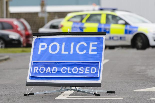 Driver hospitalised after car flips onto its roof in crash near supermarket