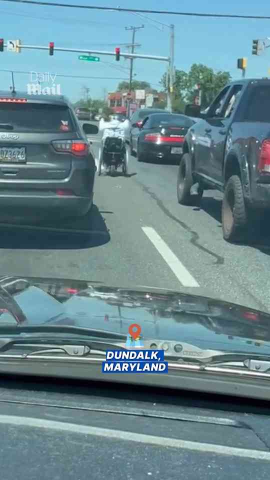 Motorized wheelchair rider draws attention on busy roadway