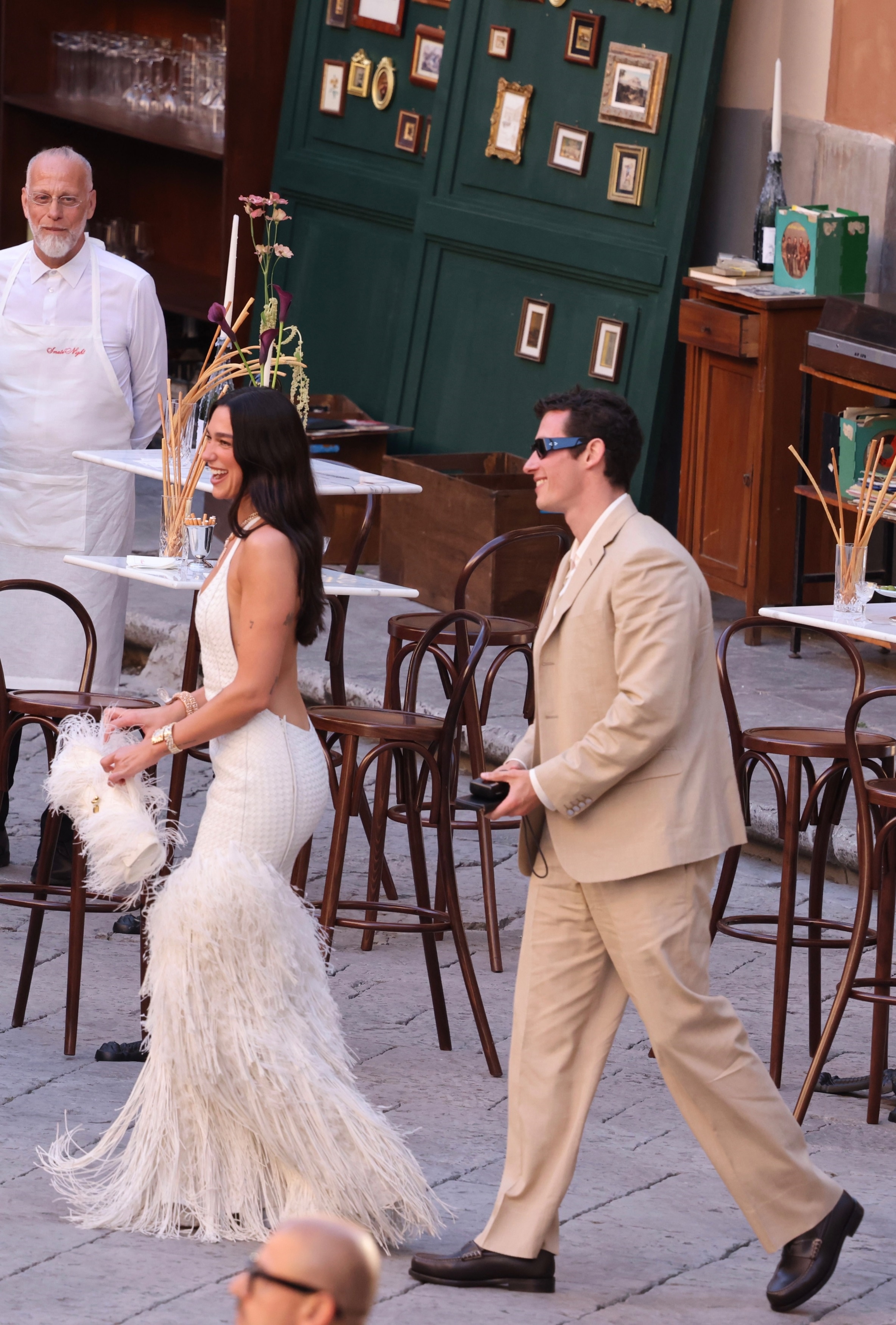 Dua Lipa kicks off her wedding weekend with white leather, feathers and ...