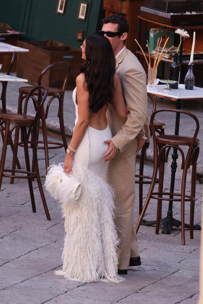 Dua Lipa kicks off her wedding weekend with white leather, feathers and ...